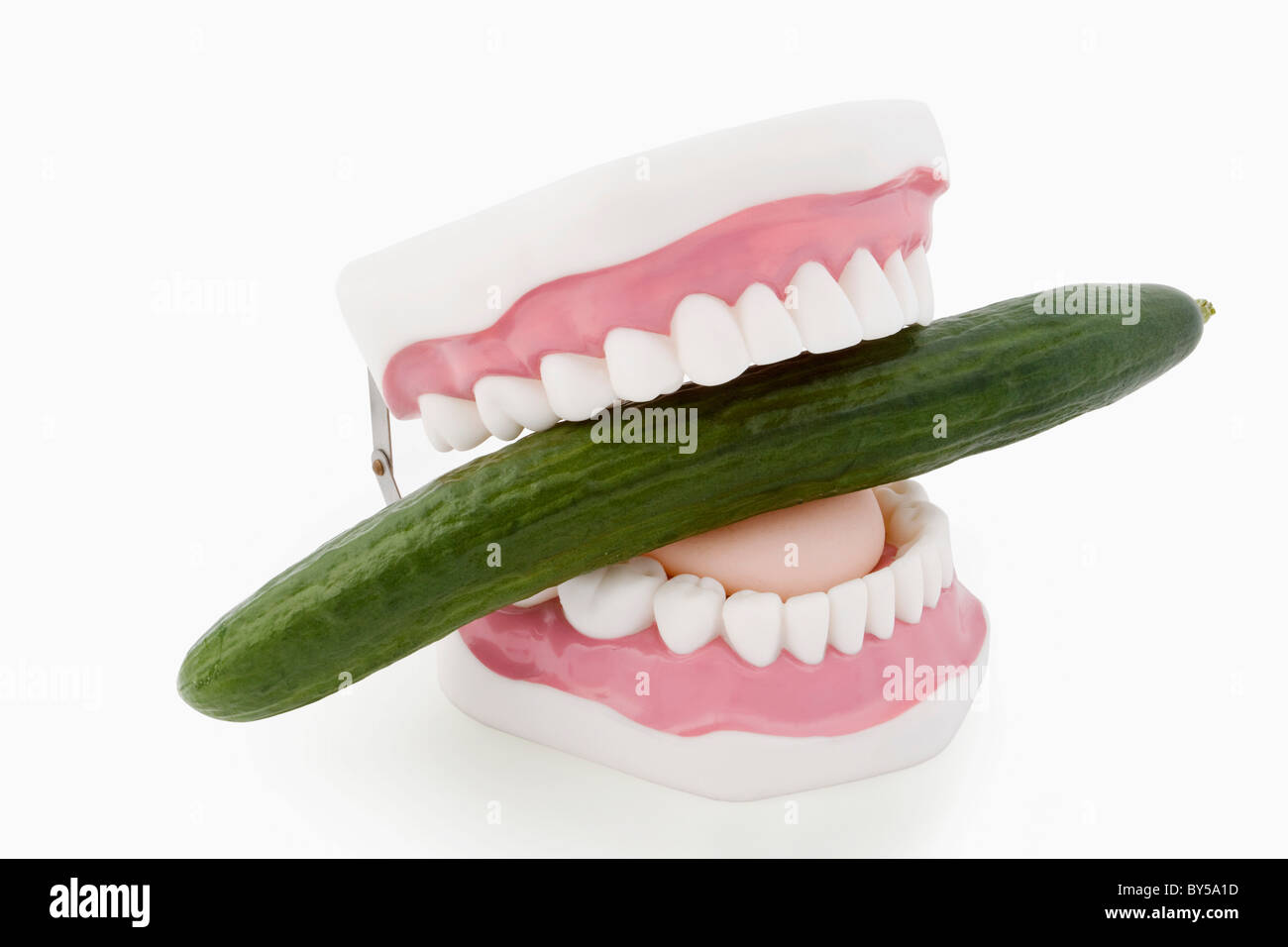 Model teeth biting cucumber Stock Photo - Alamy