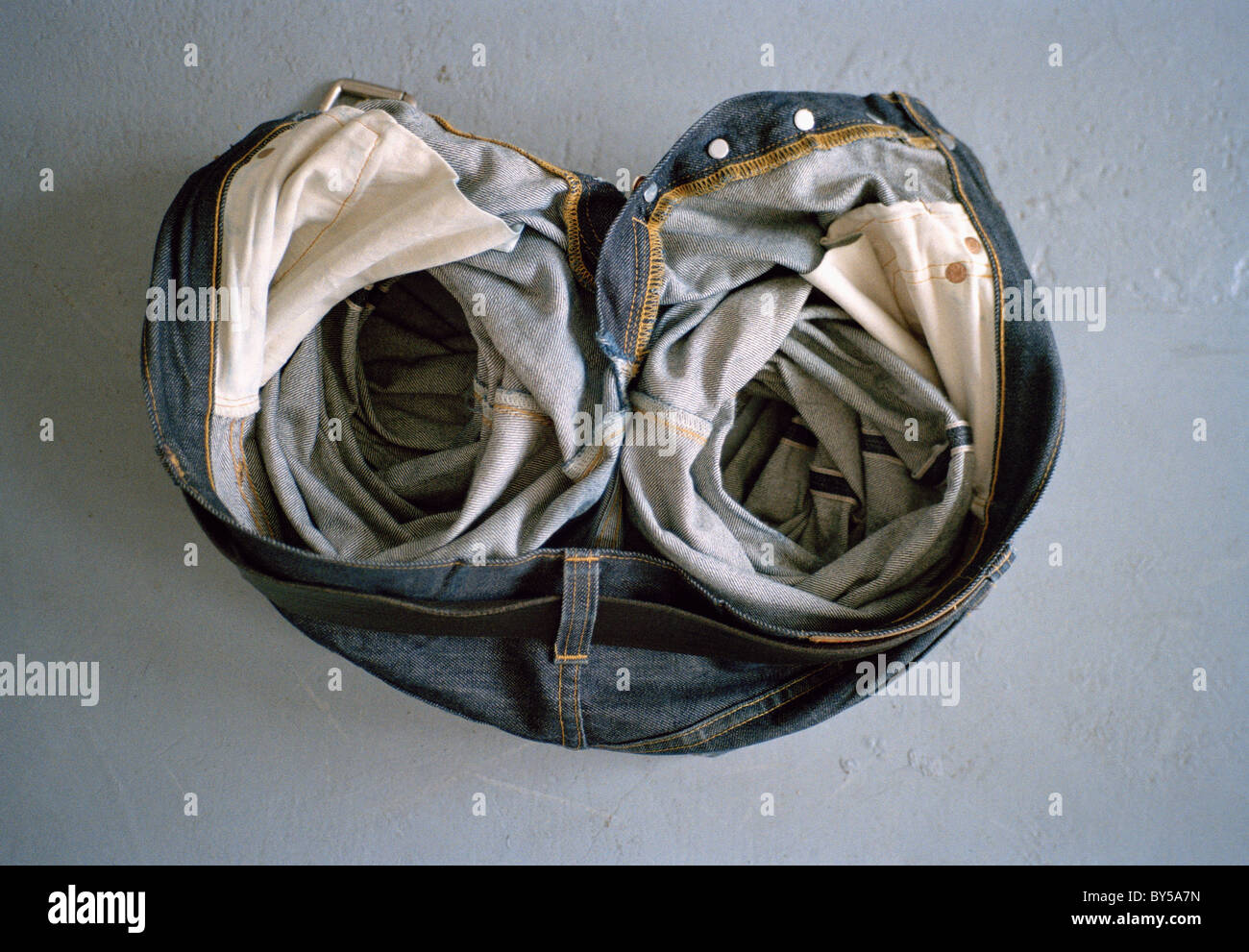A pair of crumpled jeans on the floor Stock Photo - Alamy