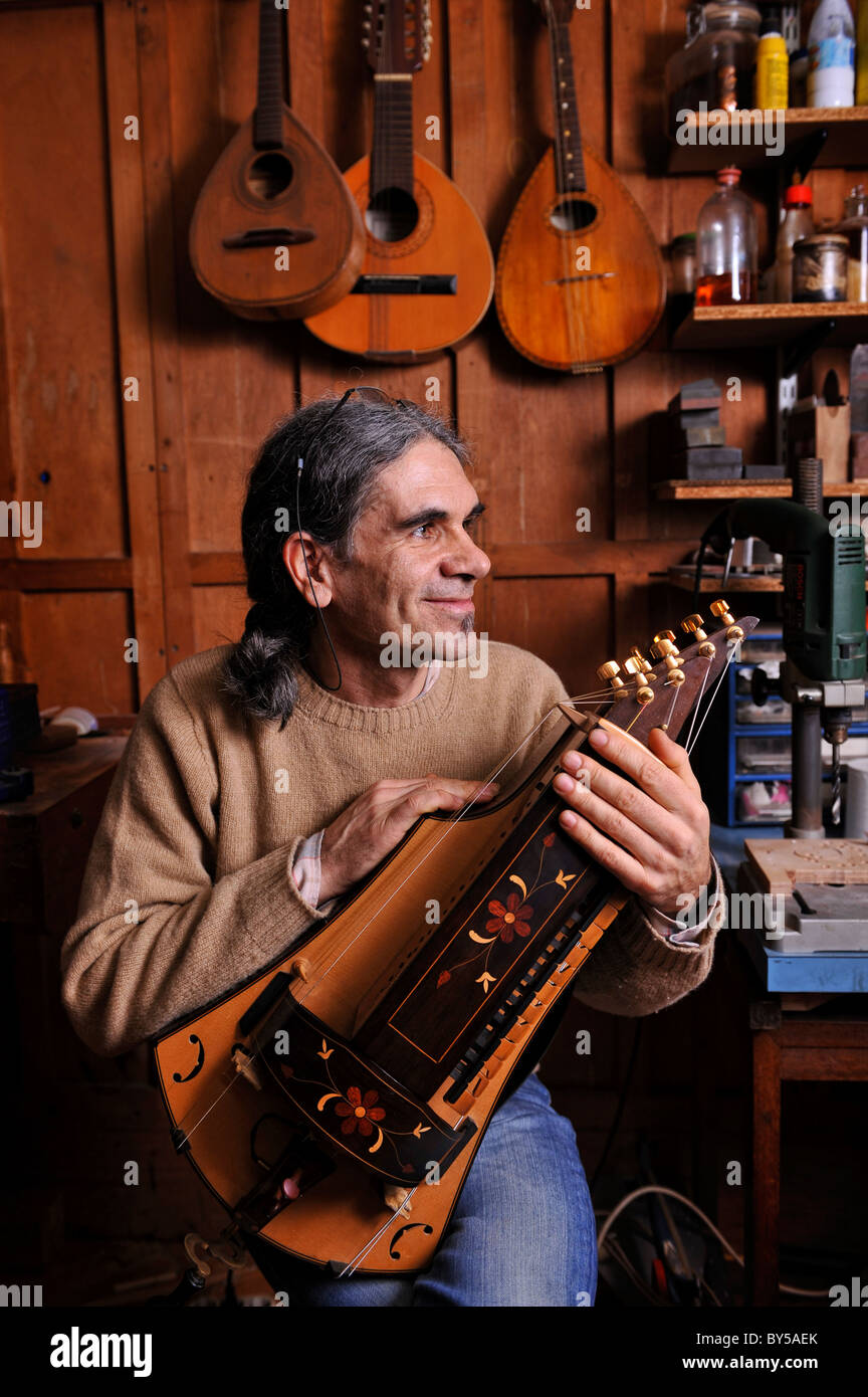 Portrait of a craftsman holding a Sanfona traditional portuguese ...