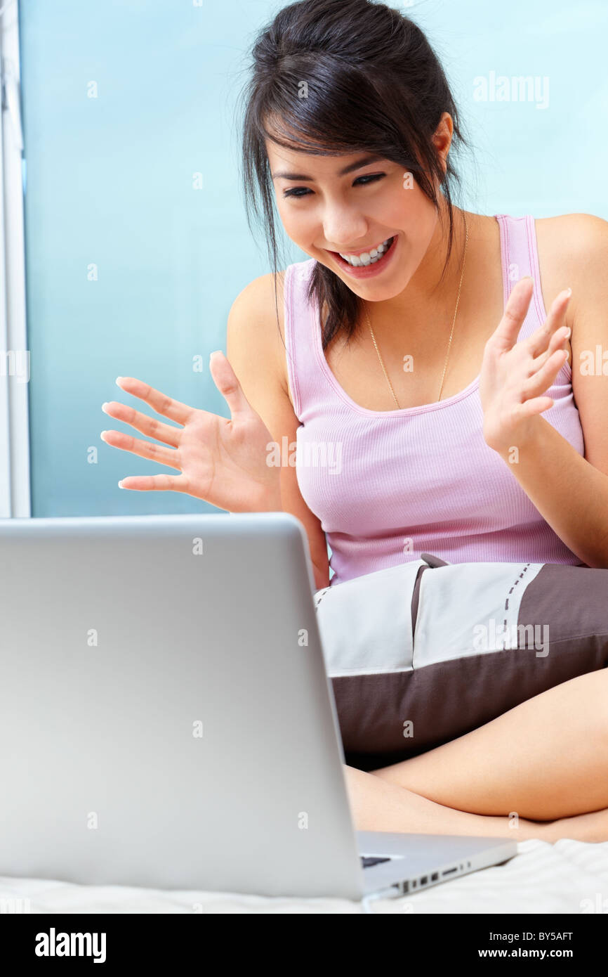 Young Asian female using laptop in her bedroom Stock Photo - Alamy