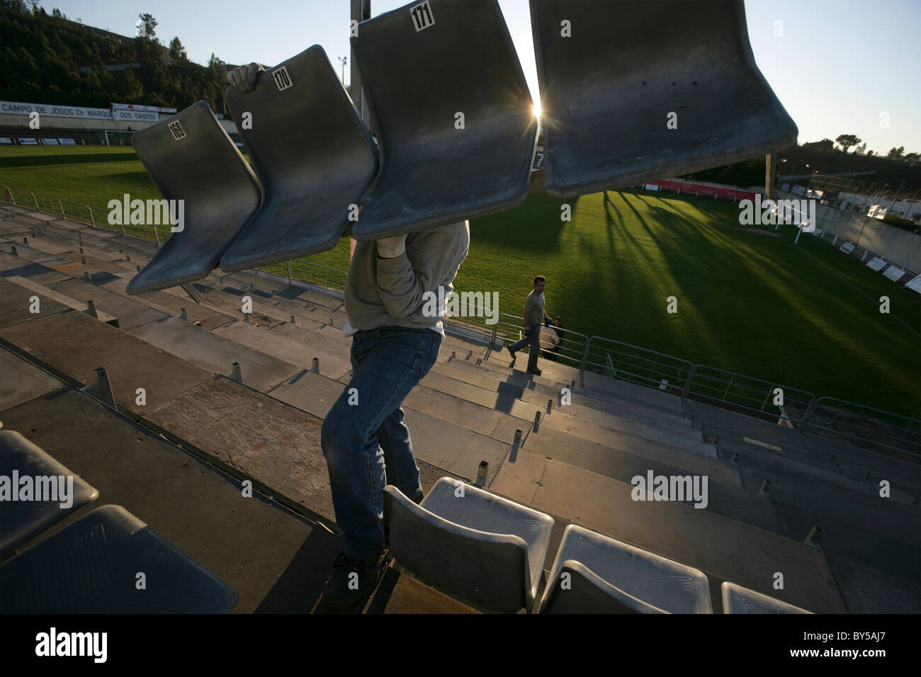 Man installing seats at a football stadium Stock Photo - Alamy