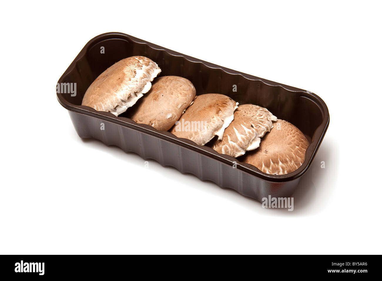 Box or packet of Portobello mushroom isolated on a white studio ...