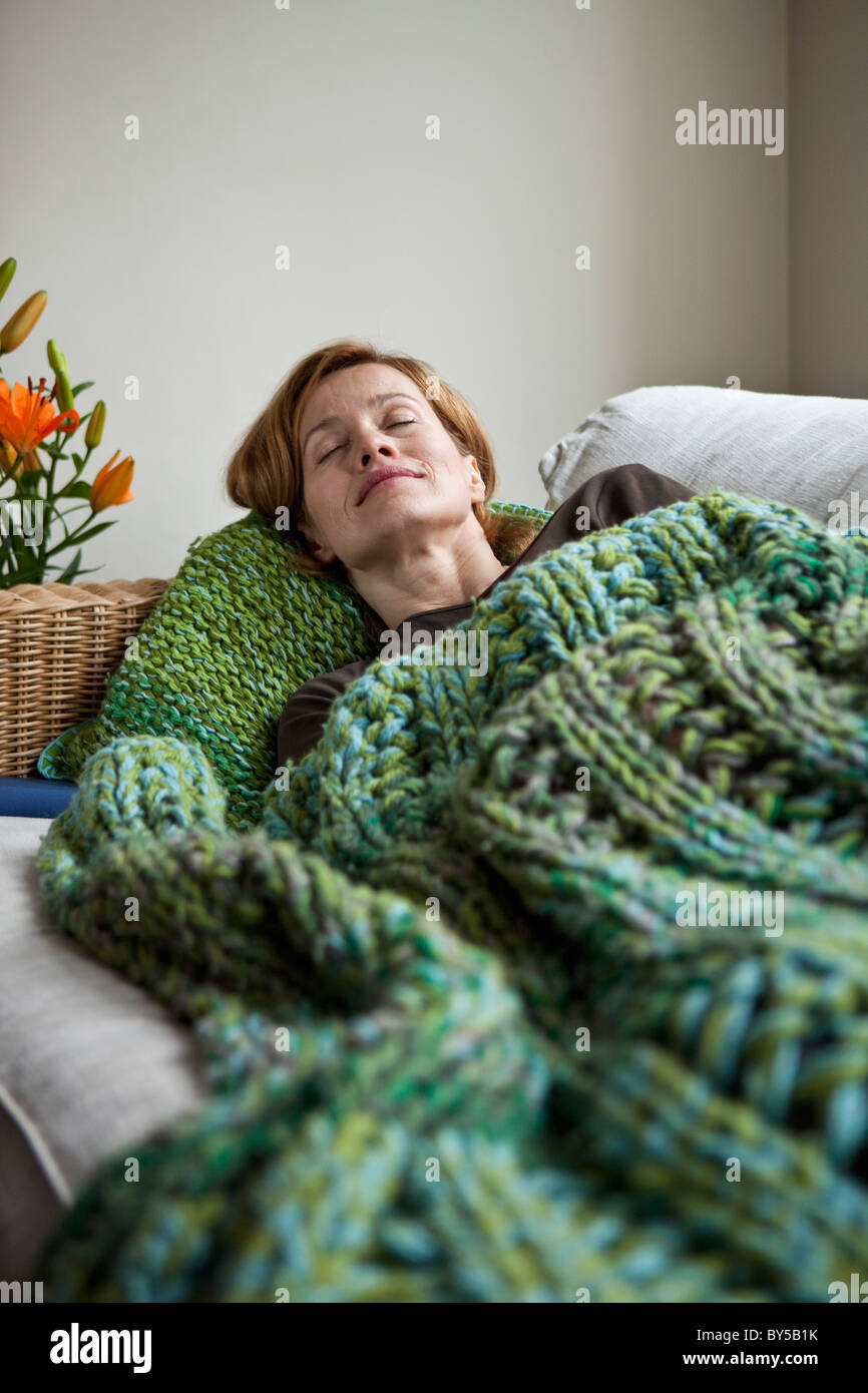 A woman napping on a sofa Stock Photo - Alamy