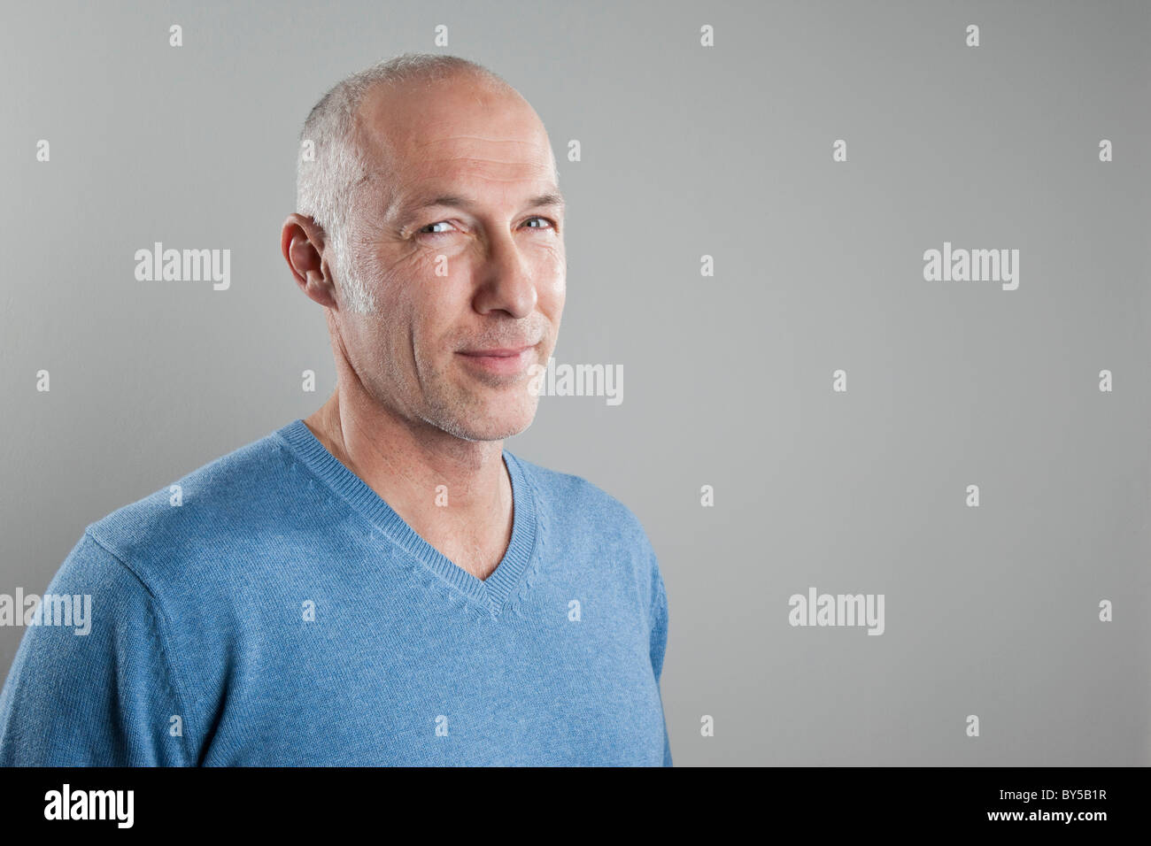 A mature man looking suspicious, portrait Stock Photo - Alamy