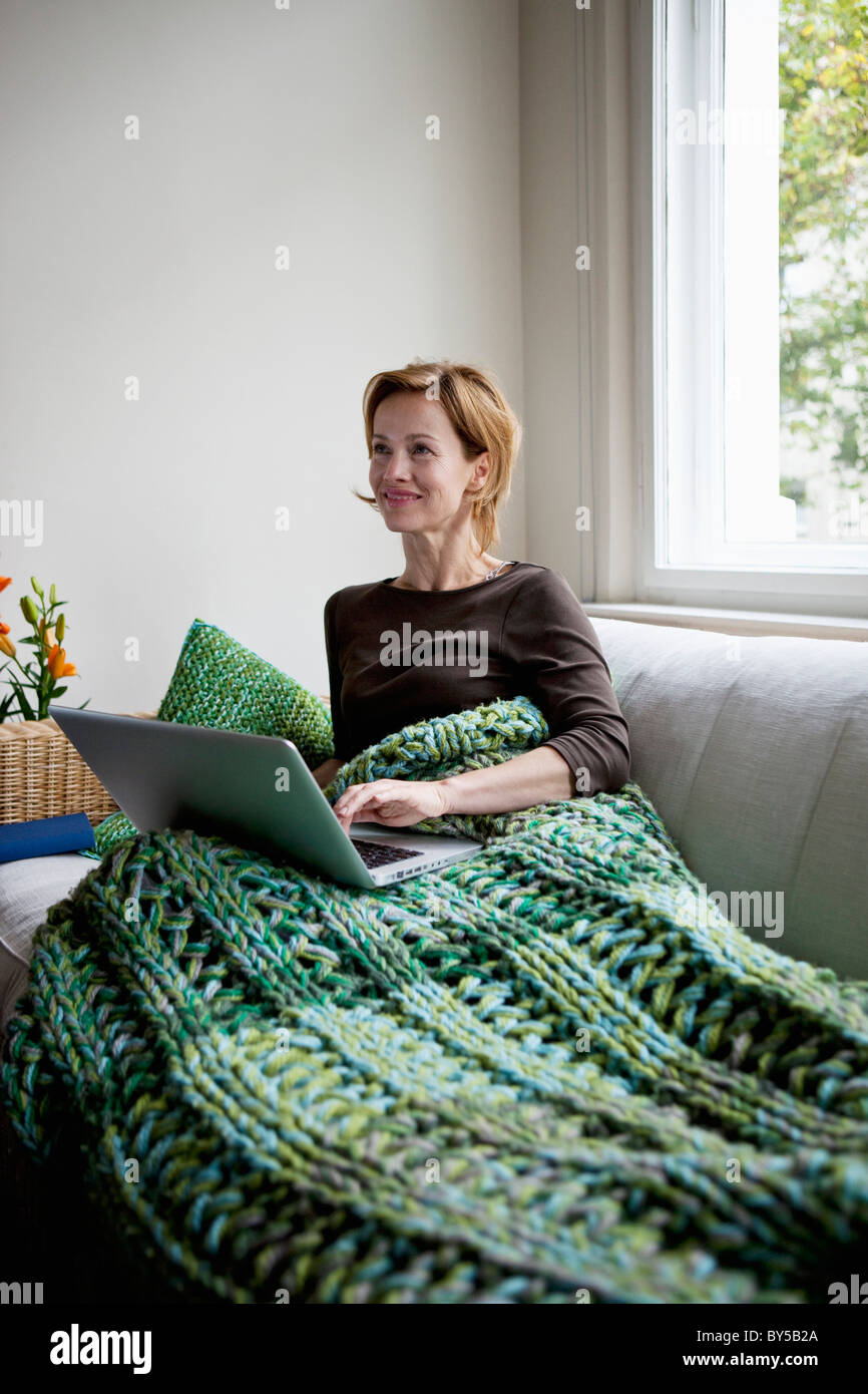 Mature woman reclining on sofa hi-res stock photography and images - Alamy