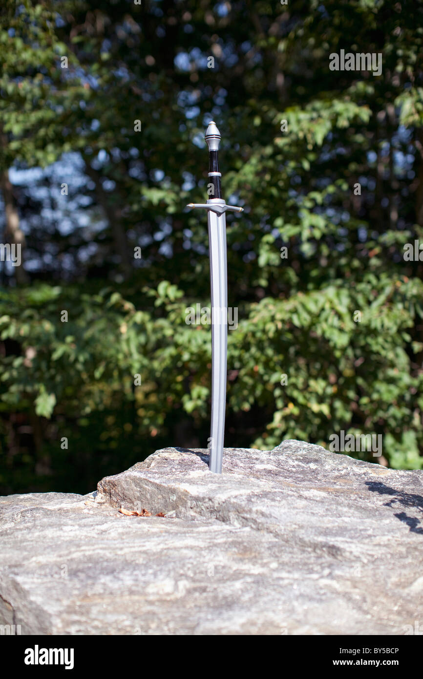 A sword stuck in a boulder Stock Photo - Alamy
