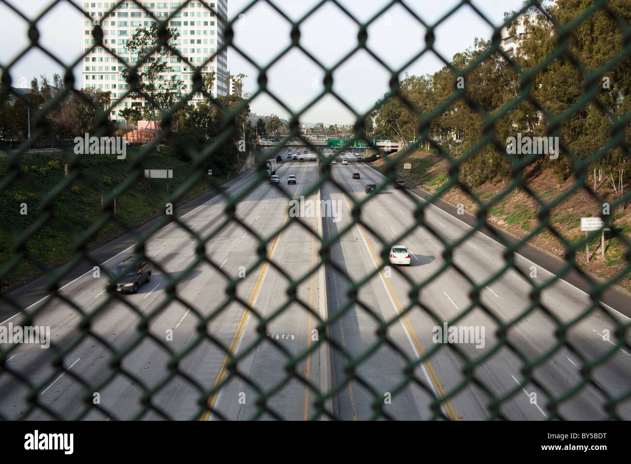 A highway seen through a chain-link fence Stock Photo - Alamy