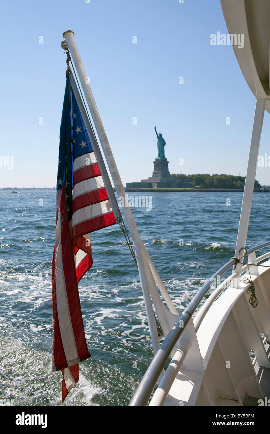 American flag on a ferry, Statue of Liberty in background Stock Photo ...