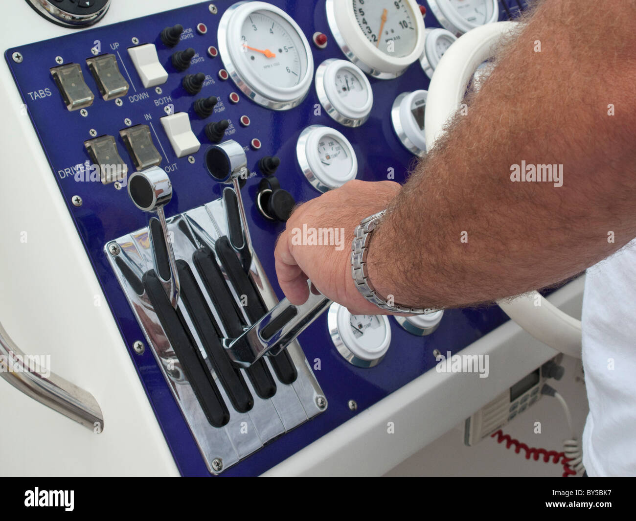 A man steering a boat, close-up of arm and hand Stock Photo - Alamy