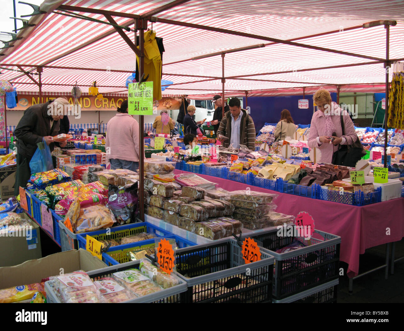people shopping on a discounted goods stall Chichester traditional ...