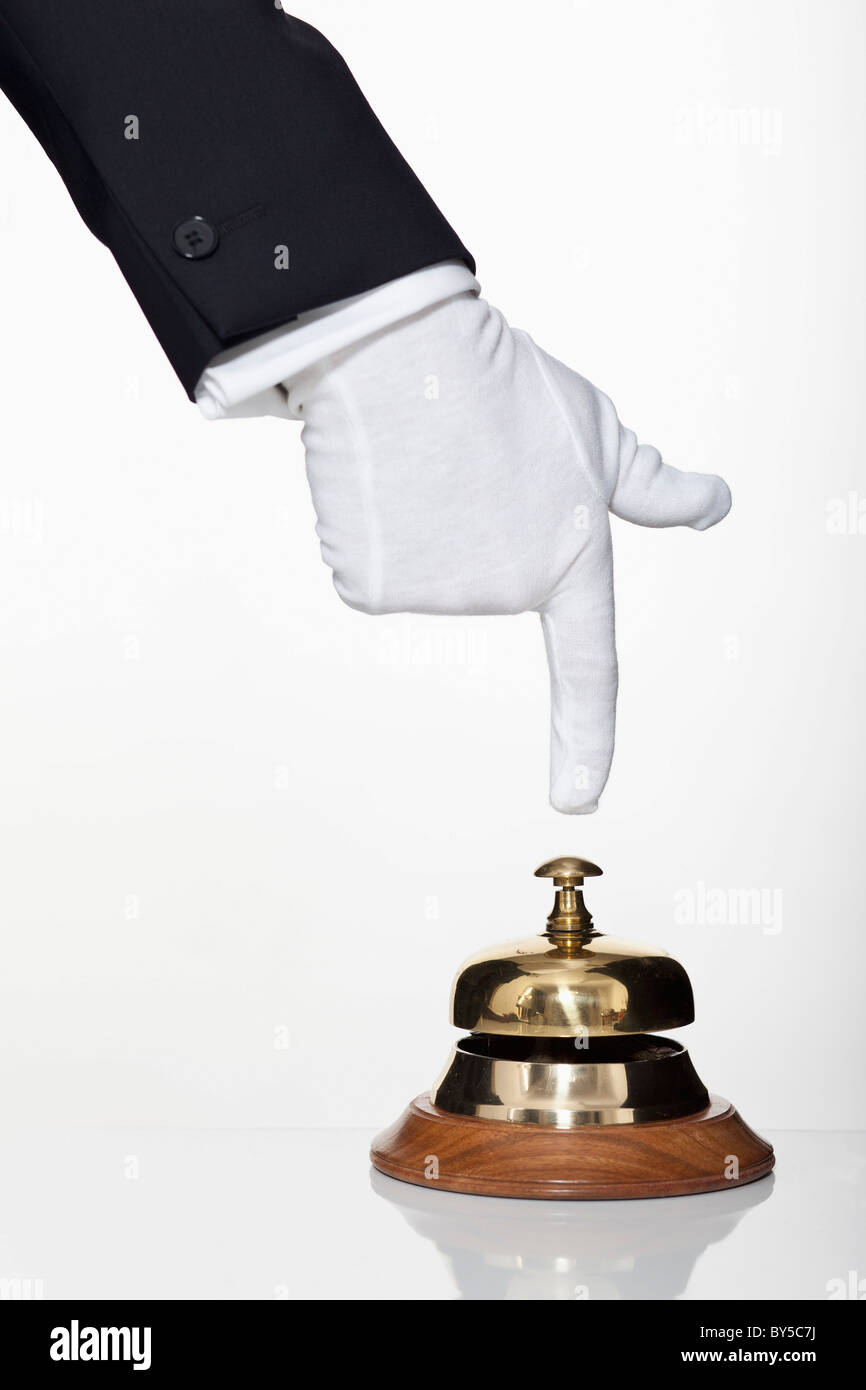 A butler pushing a service bell, focus on hand Stock Photo - Alamy