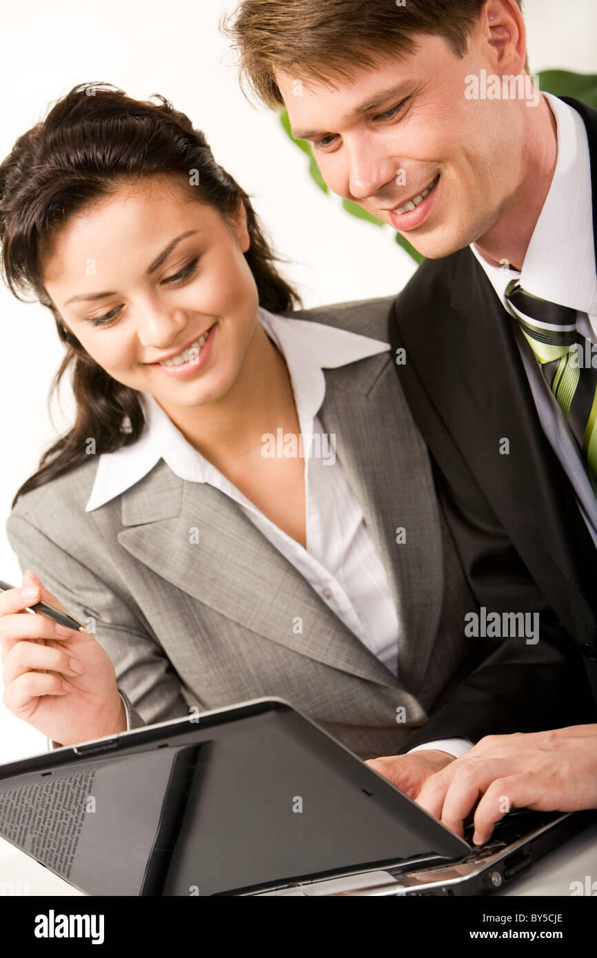 Vertical image of businessman and businesswoman doing some computer ...