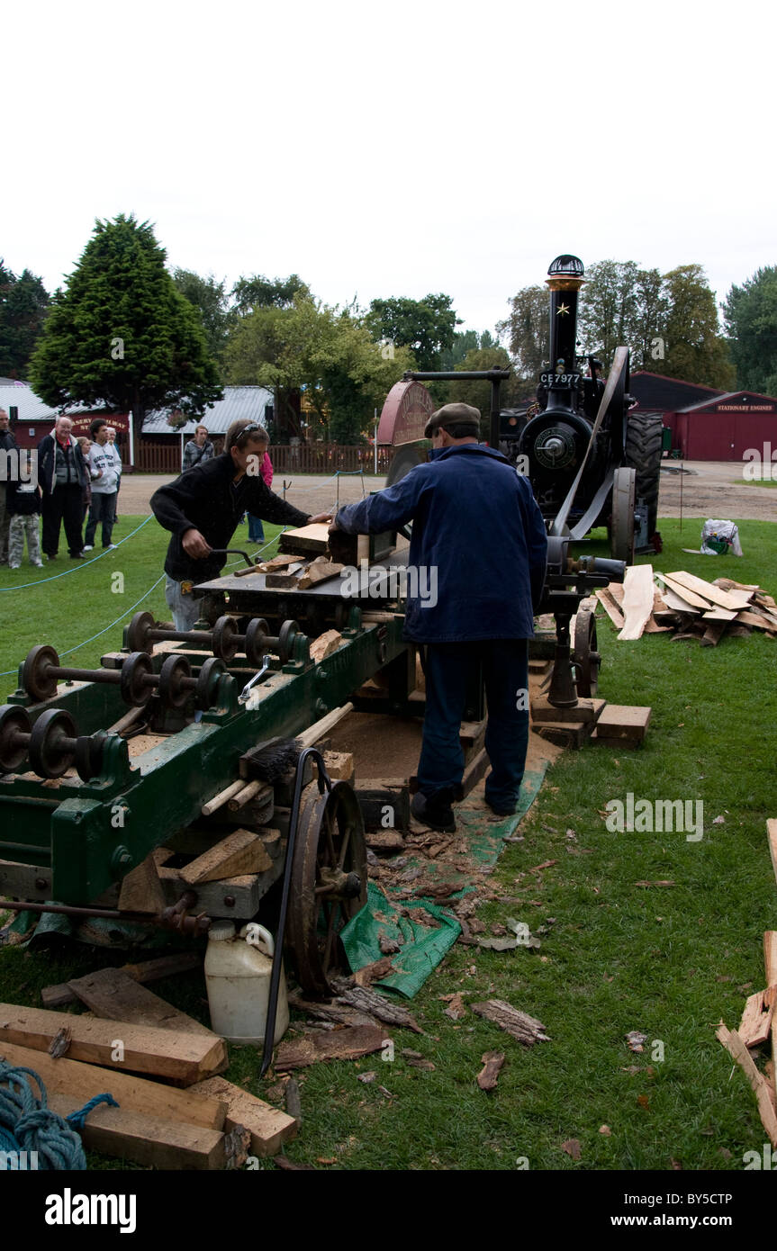 Circular saw, powered by a steam traction engine, cutting wood at ...