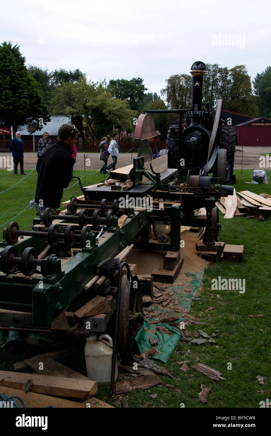 Circular saw, powered by a steam traction engine, cutting wood at ...