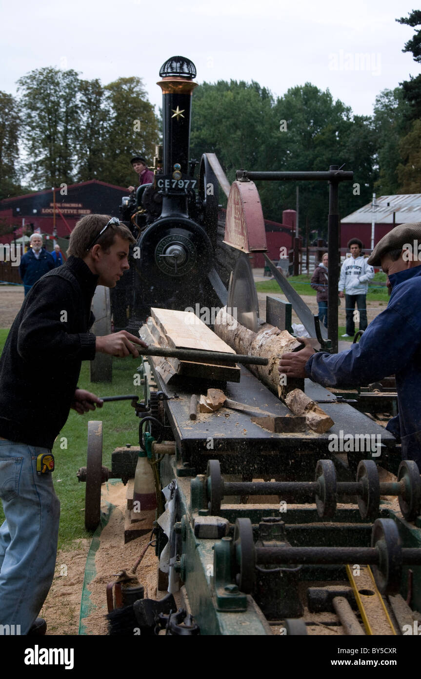 Circular saw, powered by a steam traction engine, cutting wood at ...