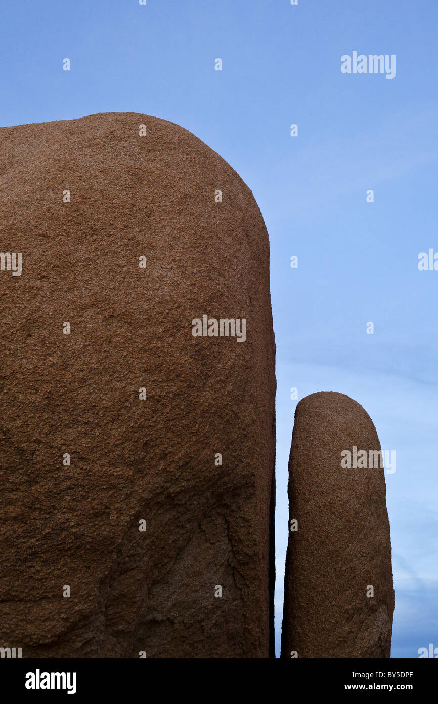 Granite rock formations against a deep blue sky at dusk in Joshua Tree ...