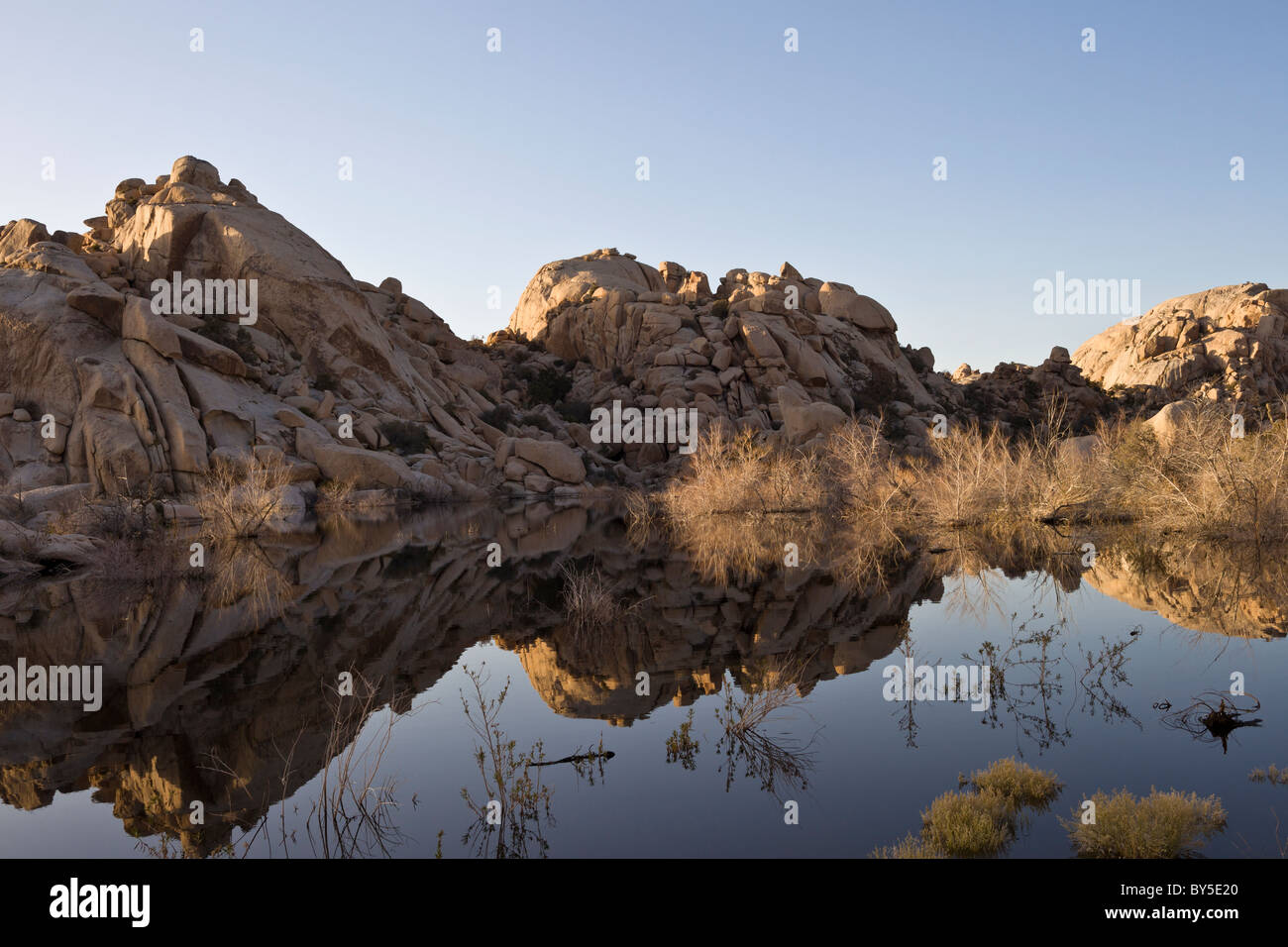Rock formations reflecting in the reservoir at Barker Dam or Big Horn ...