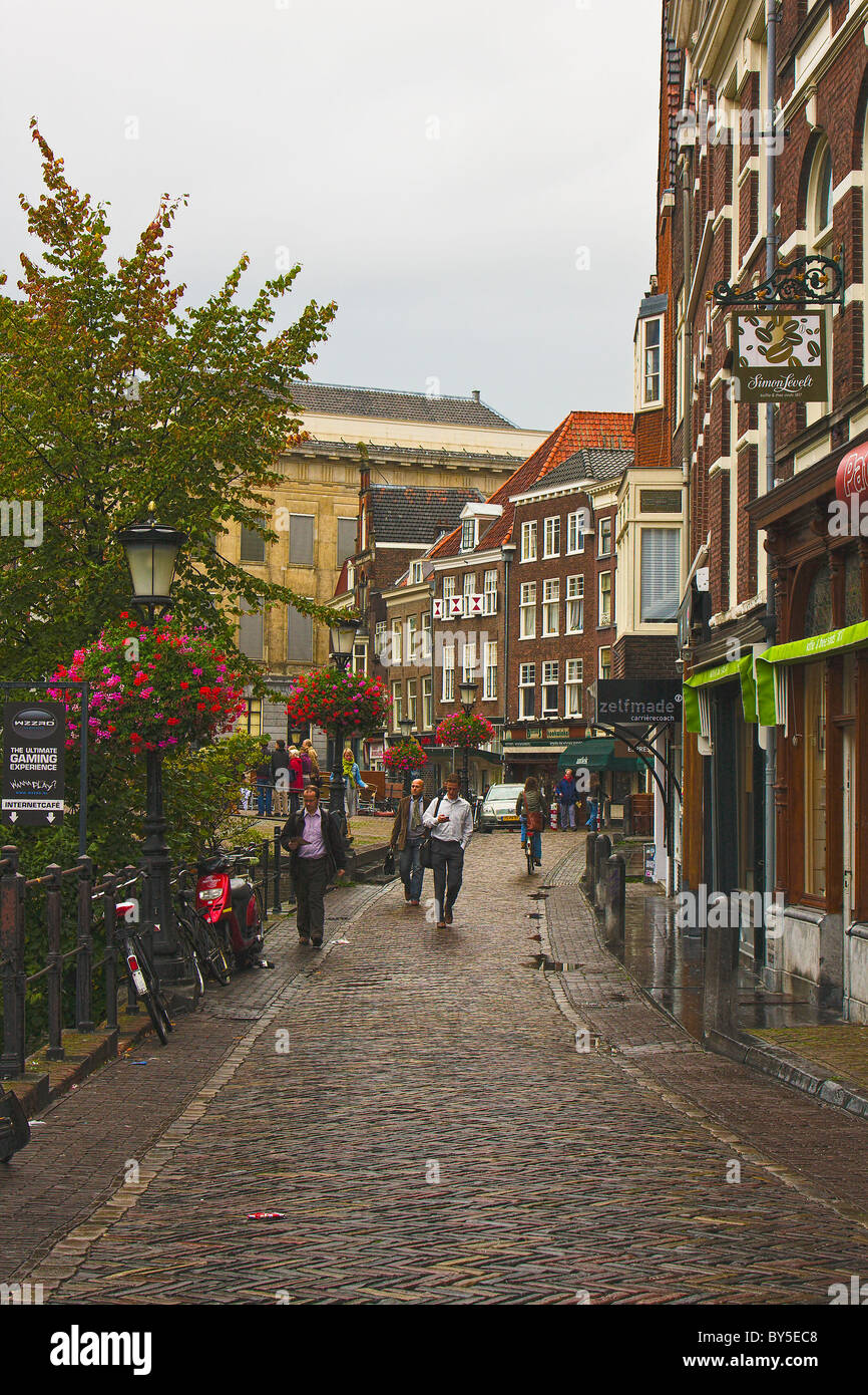 Utrecht, Netherlands city street with people walking; gray overcast day ...