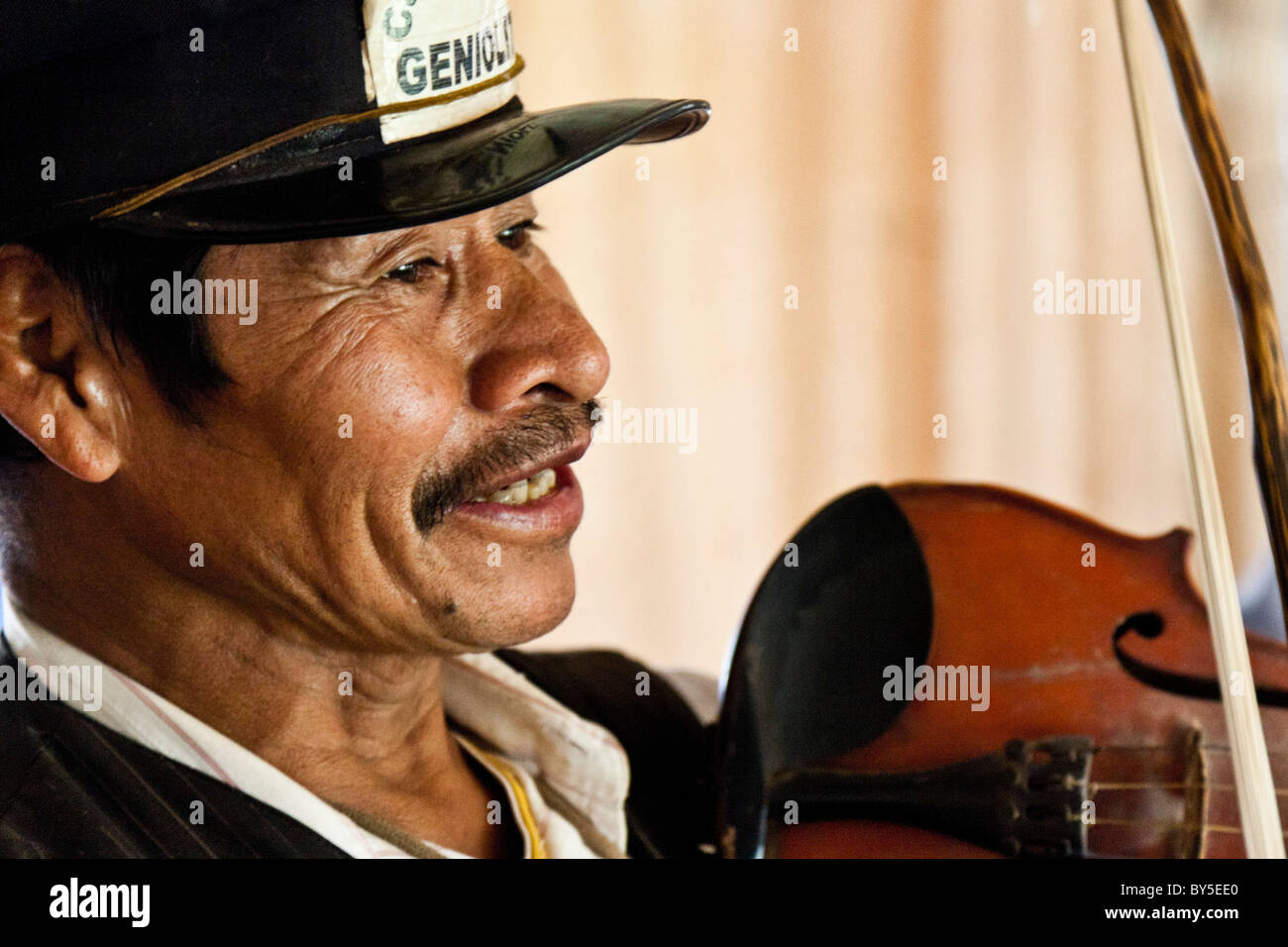 Mbya Guarani chief "Cacique Geniolito" playing violin in a restaurant ...