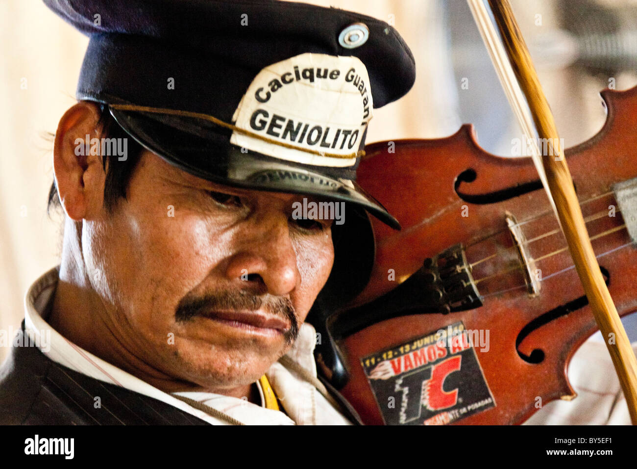 Mbya Guarani chief "Cacique Geniolito" playing violin in a restaurant ...