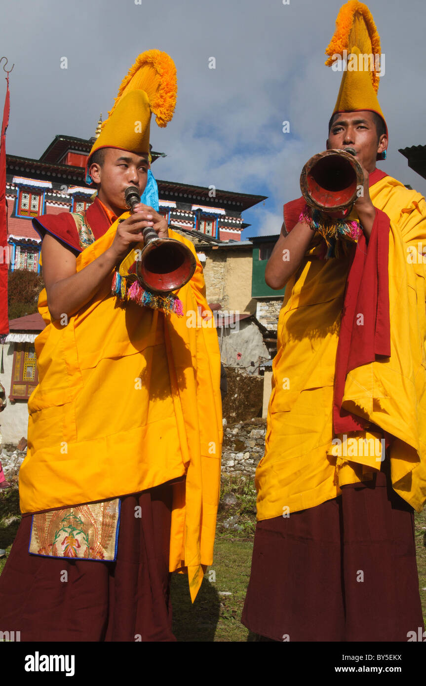 yellow hat Gelugpa monks blowing horns at the Mani Rimdu Festival at ...