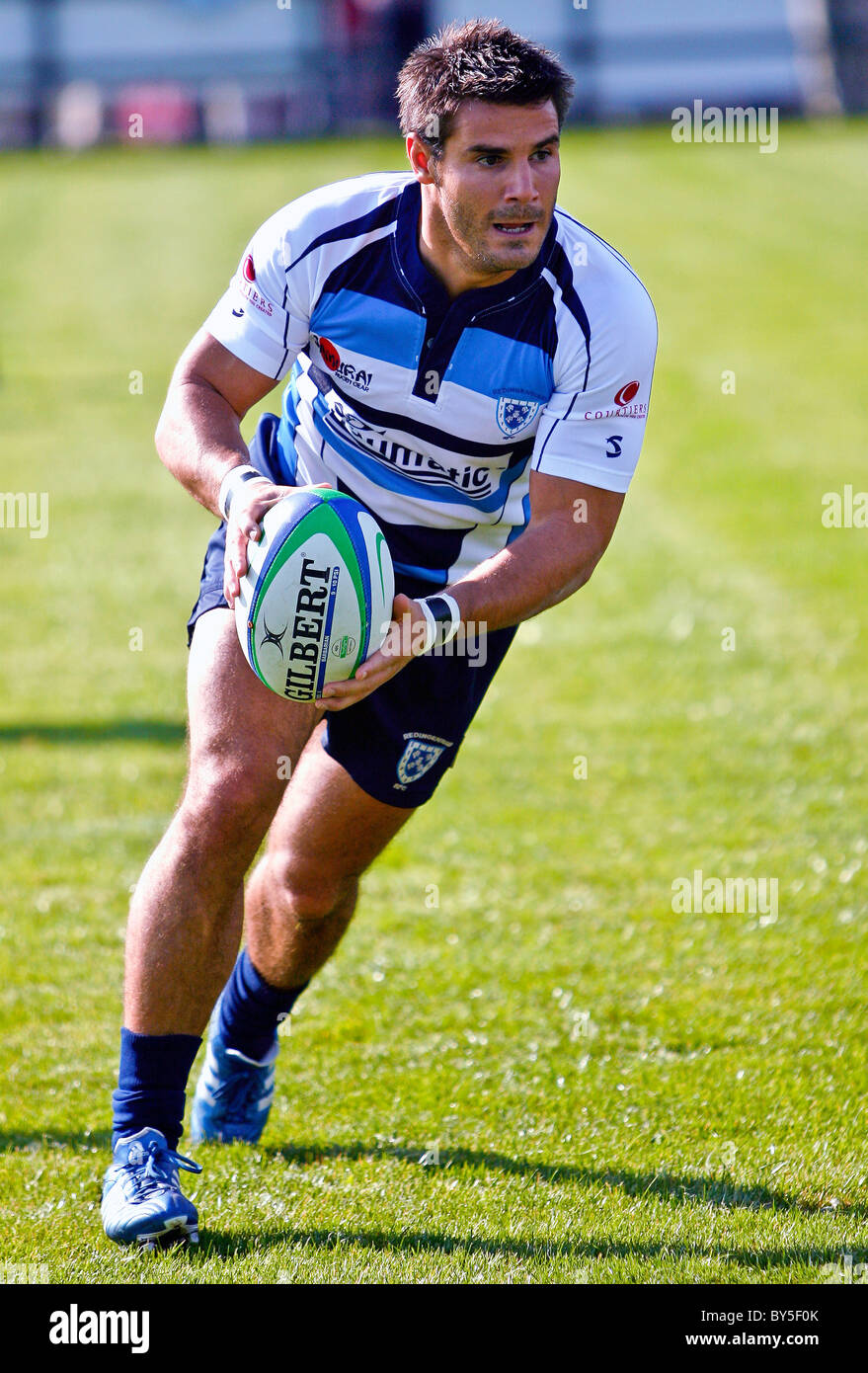 A rugby player with ball makes a break during a game in the Uk Stock ...