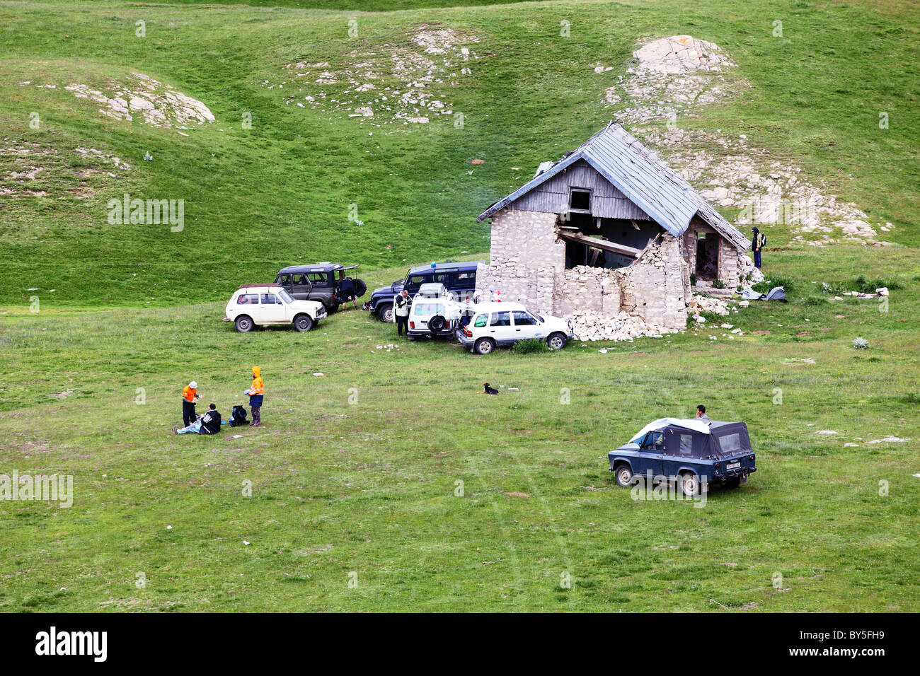 mountaineers gathering on the Begovo Field, below mountain peak ...
