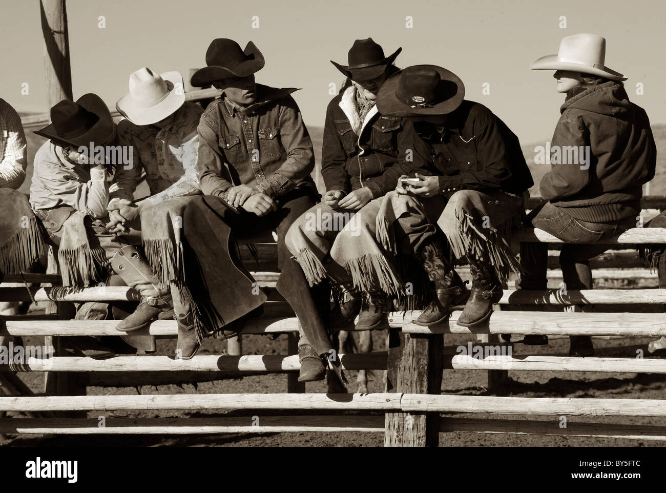 Cowboys on Fence at Sombrero Ranch, Colorado Stock Photo - Alamy