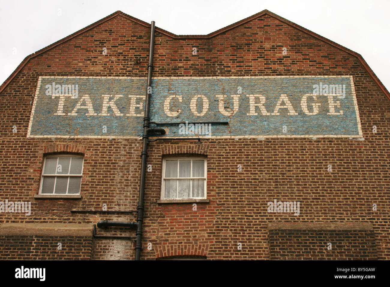 Take courage a simple factory slogan Stock Photo - Alamy