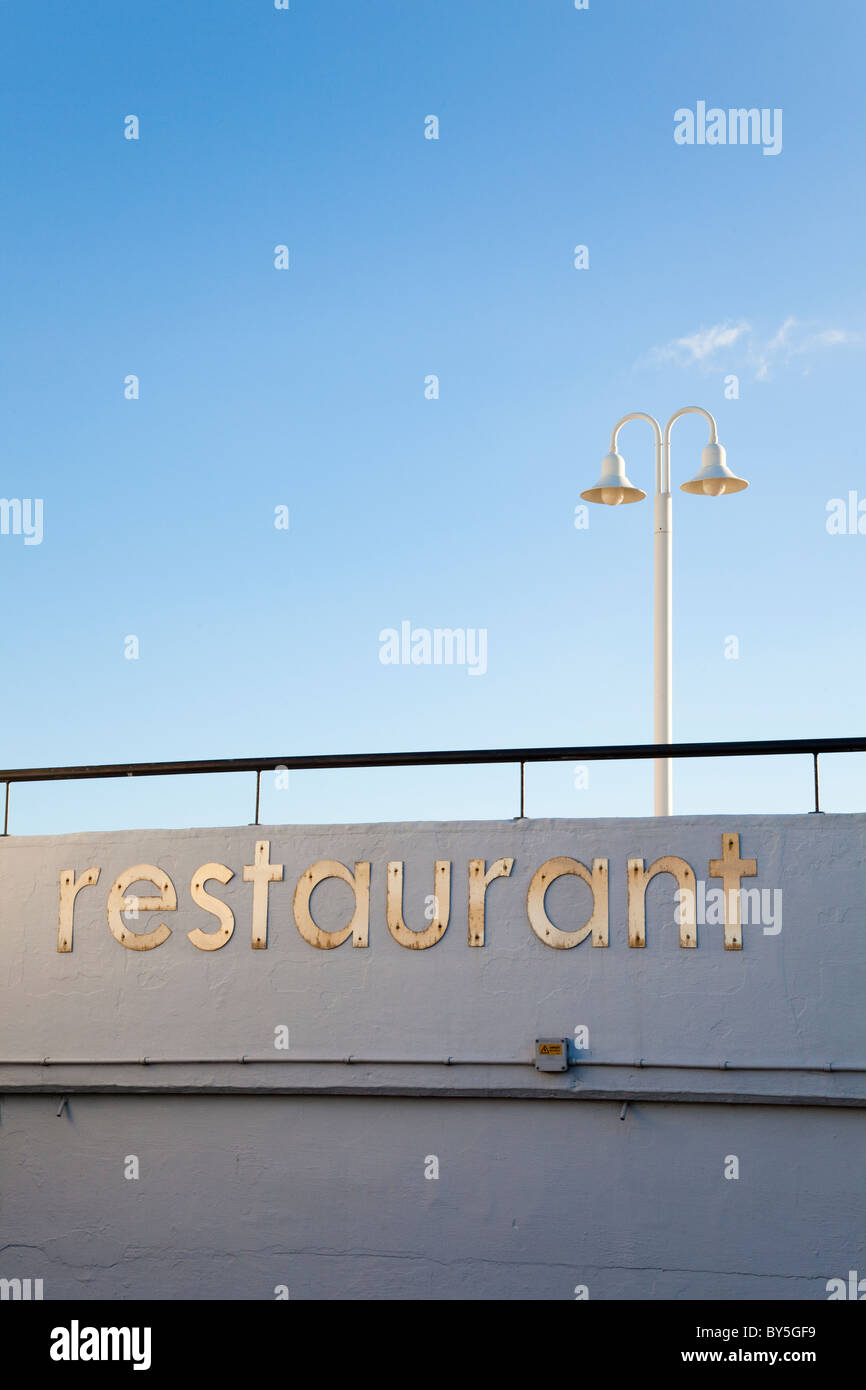 Restaurant sign, street light and blue sky, Essex, UK Stock Photo - Alamy