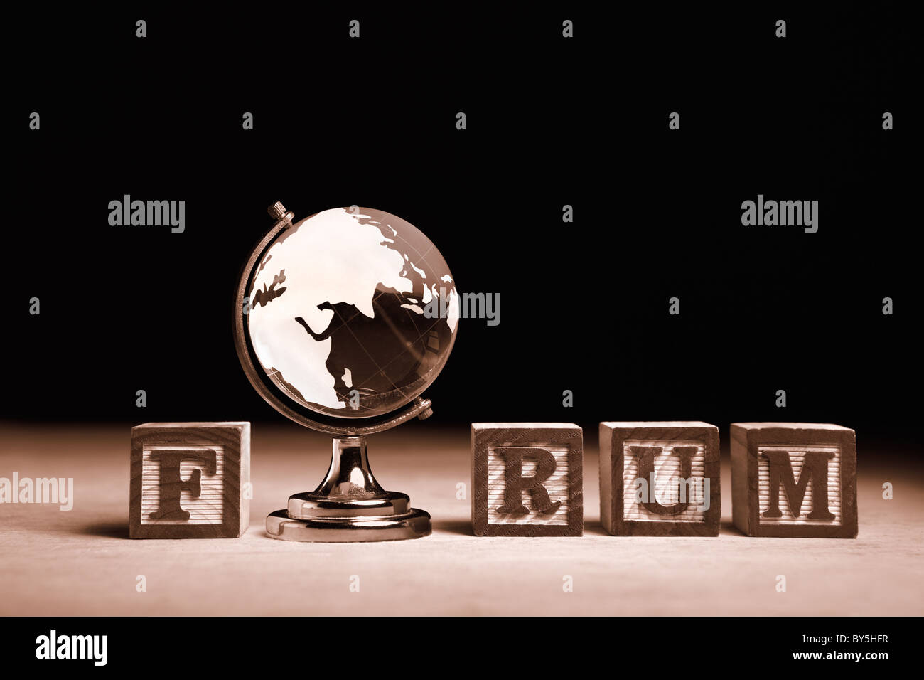 Word 'Forum" consisting alphabeth block and a globe over dark ...