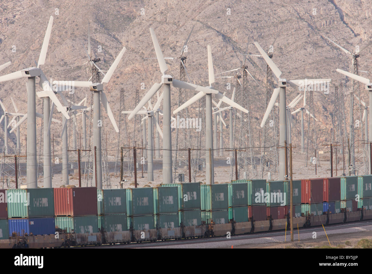 A Union Pacific container train passes wind turbines generating ...