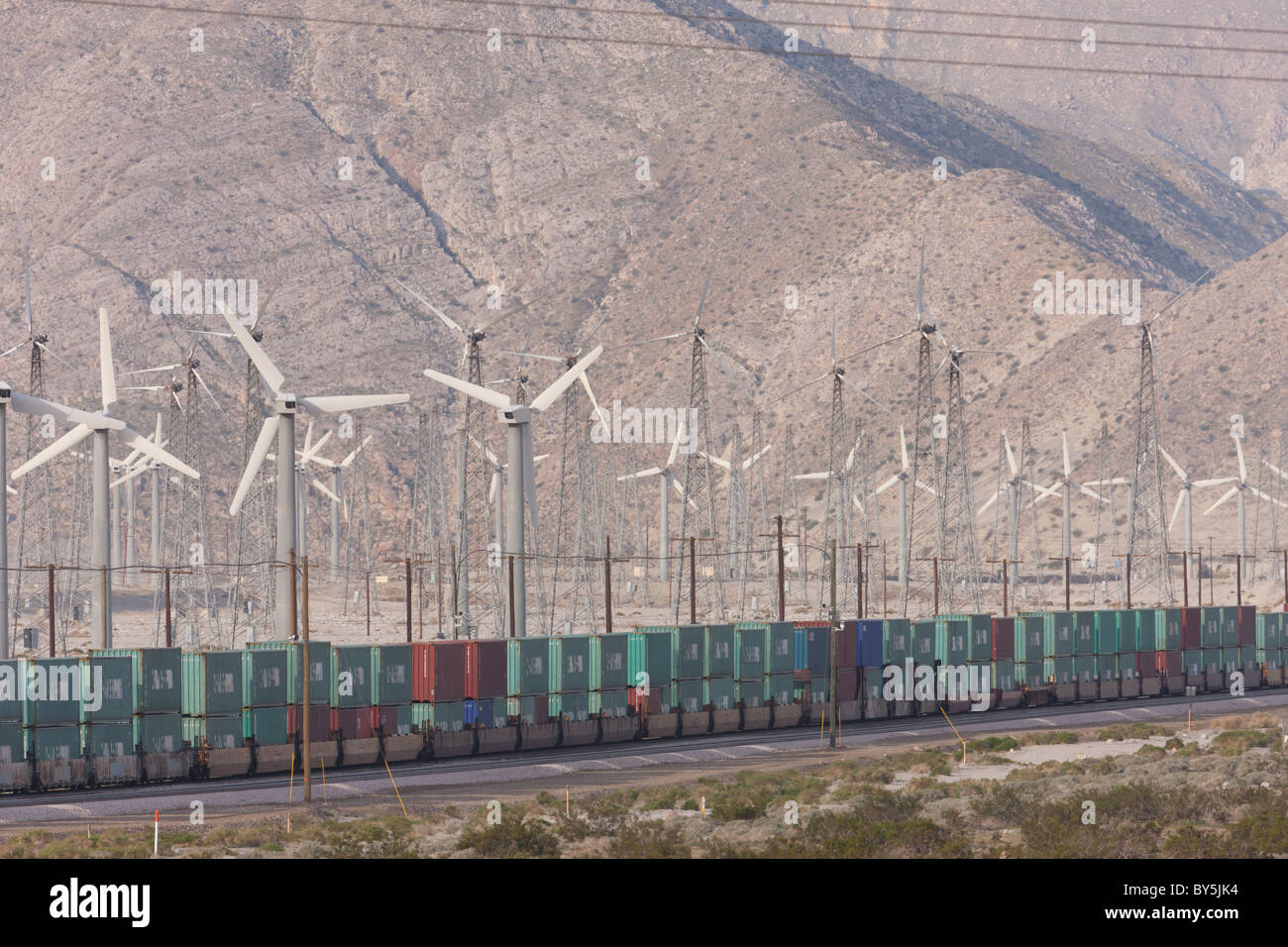 A Union Pacific container train passes wind turbines generating ...