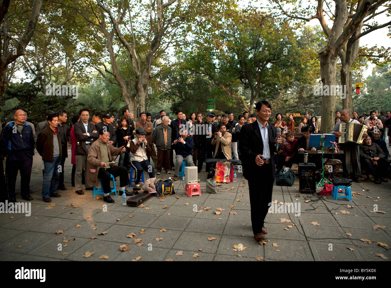 Man talking into microphone in Luxon Park, Shanghai, China Stock Photo ...