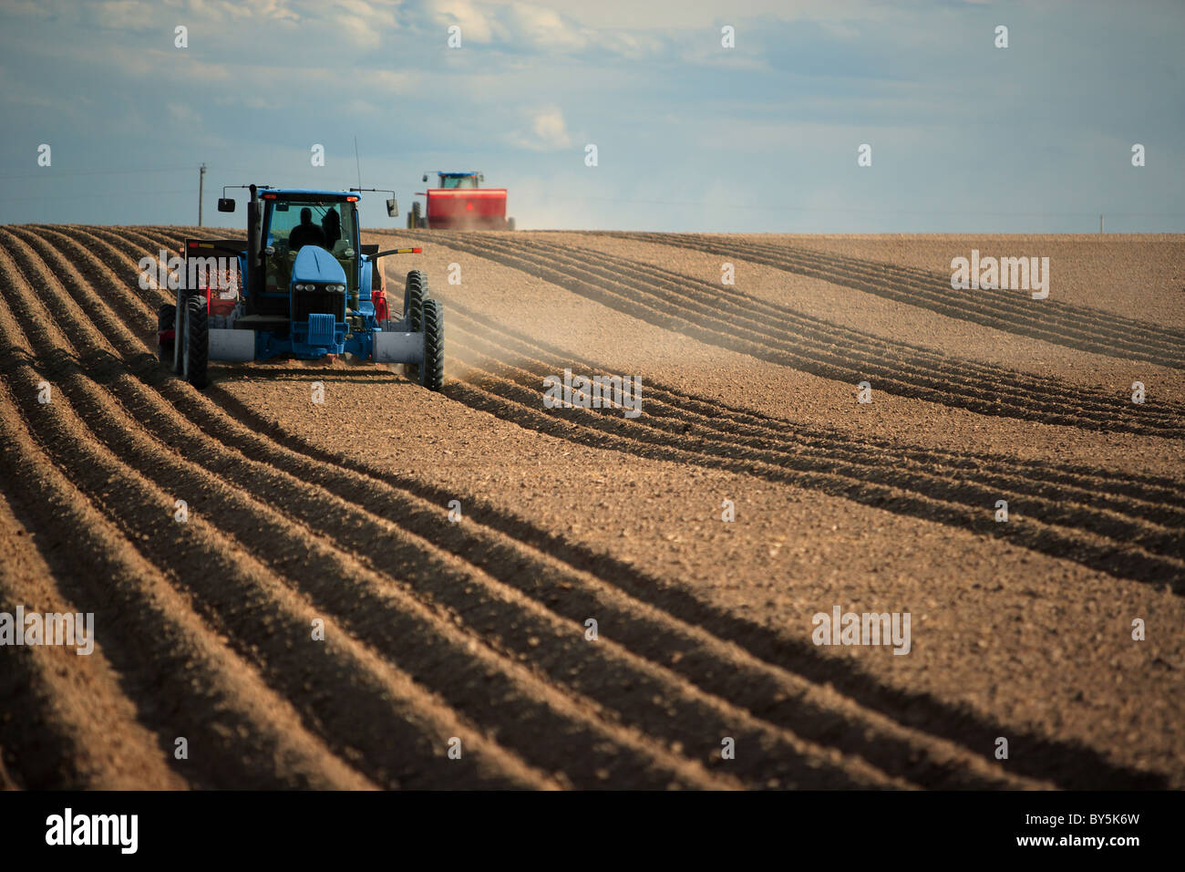 Image of two Tractors planting farm fields Stock Photo - Alamy