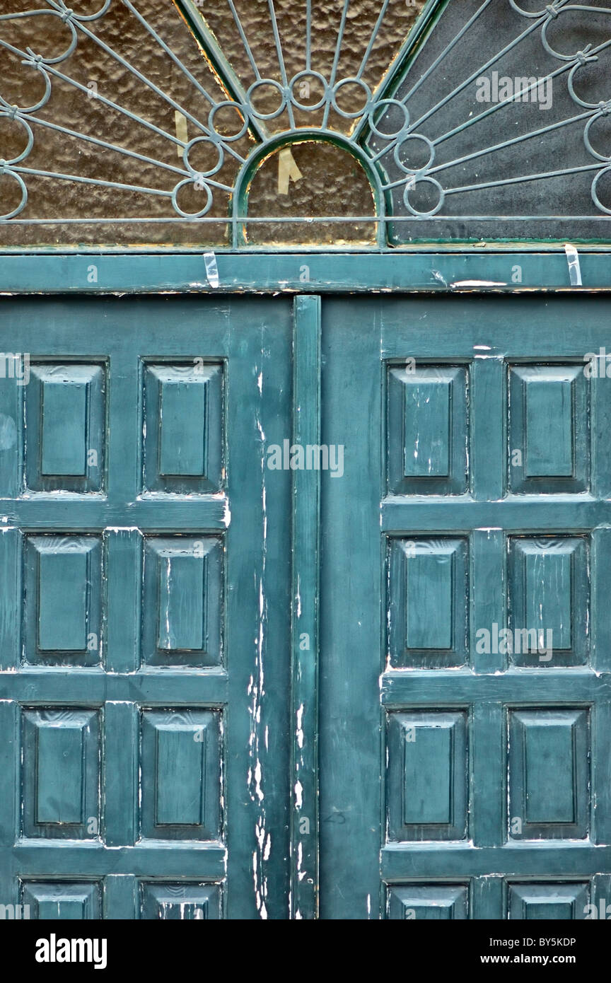 Weathered blue wooden gate with vintage ornamental sun pattern ...