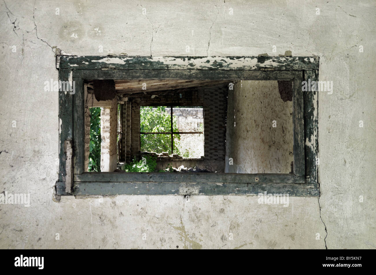 Wooden weathered window frame and crumbling wall in abandoned building ...