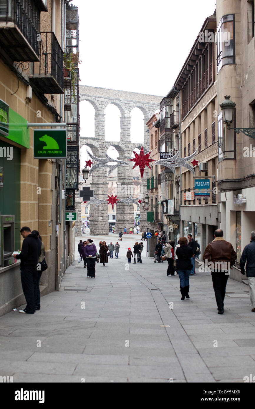 People walking down the street during winter in Segovia, Spain. Roman ...