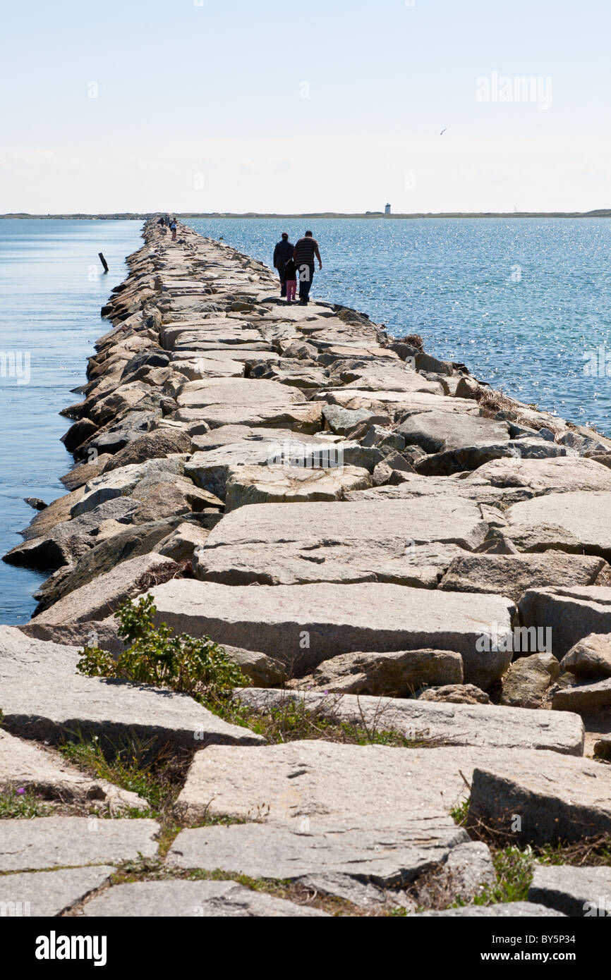 Visitors walk across west end of Provincetown Harbor on stone walkway ...