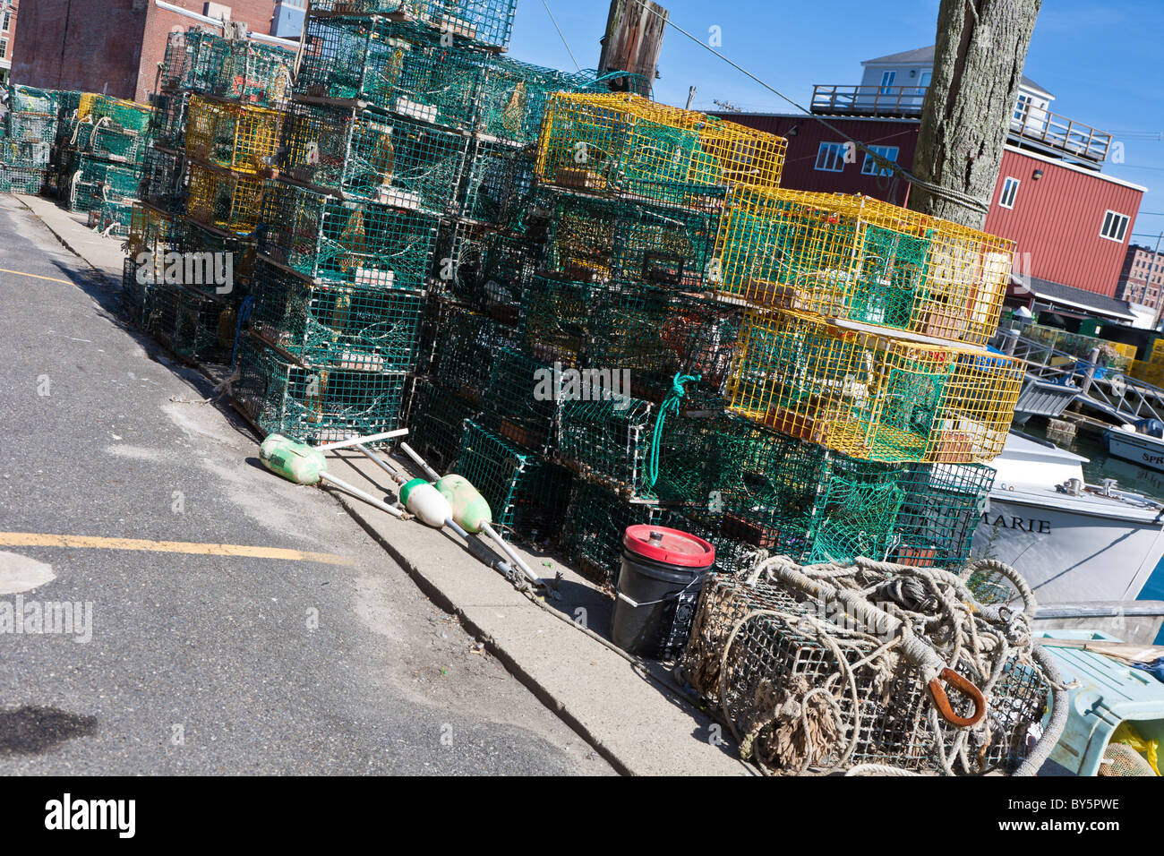 Lobster traps and float buoys stacked on wharf in Portland, Maine Stock ...