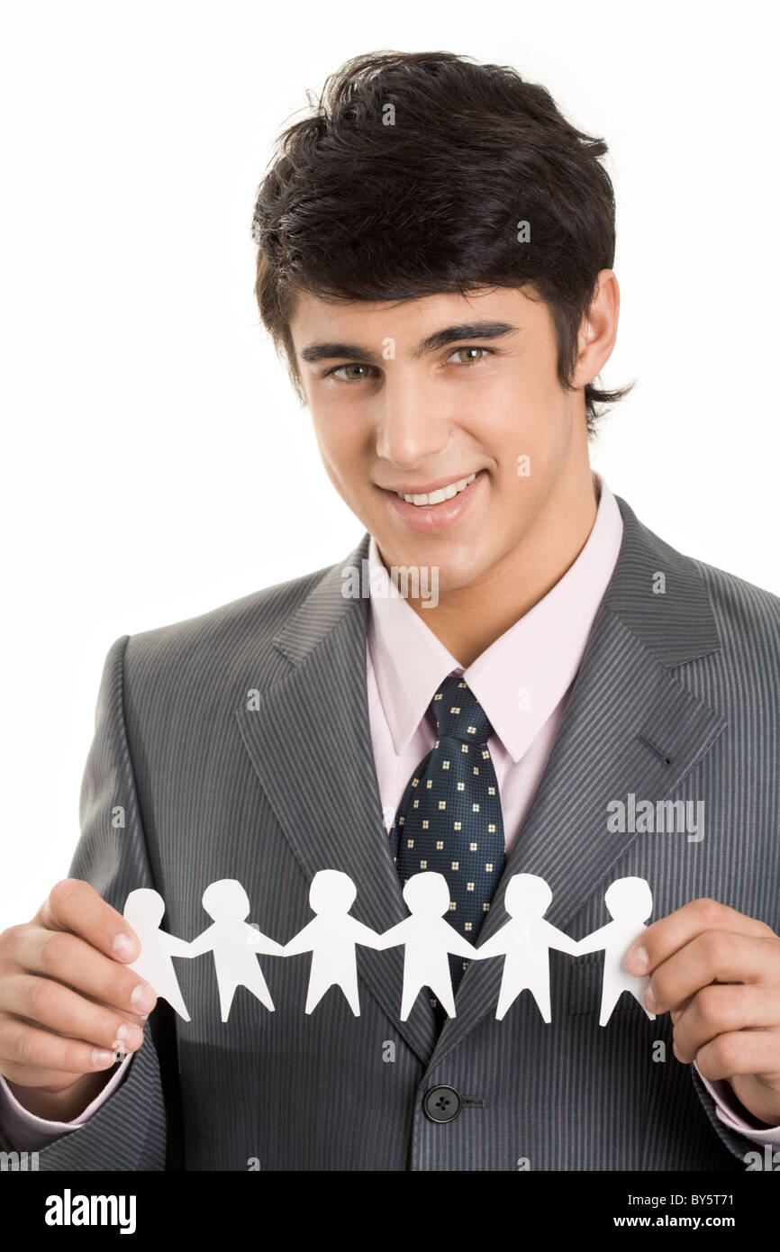 Photo of handsome man holding symbolic paper people in hands Stock ...