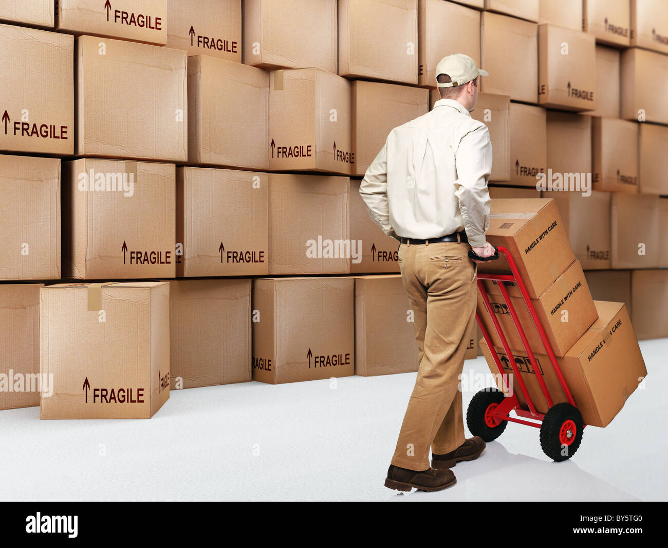 delivery man at work and 3d boxes background Stock Photo - Alamy