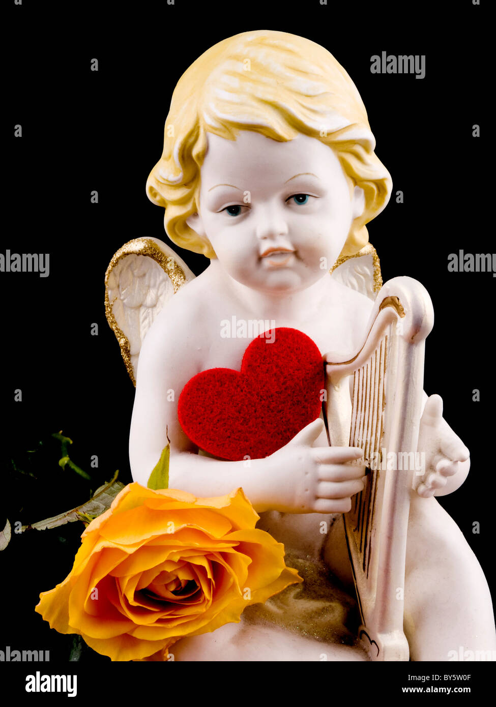 Ceramic cupid figure with felt red heart and yellow rose on black ...