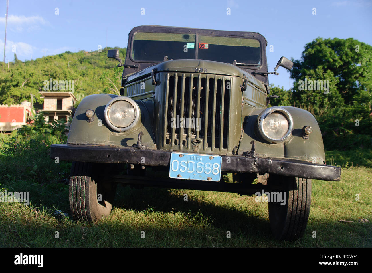 Cuban jeep parked in a field in Holguin (Cuba) with the Loma background ...