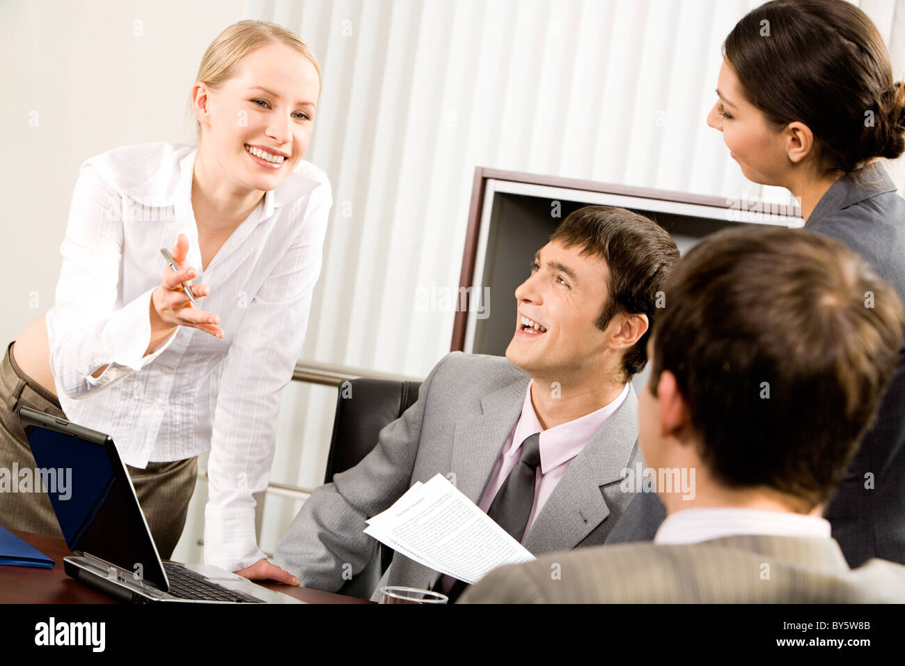 Portrait of business woman explaining her new working idea to co ...