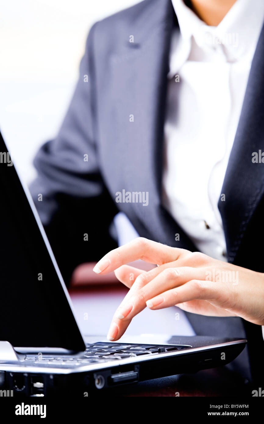 Magnified photo of business woman pushing button of laptop Stock Photo ...