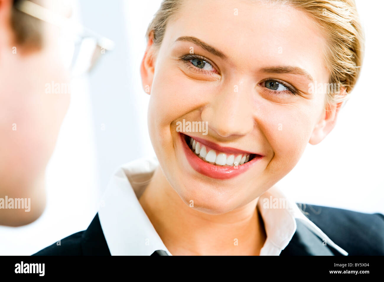 Portrait of young smiling woman gazing at business man Stock Photo - Alamy