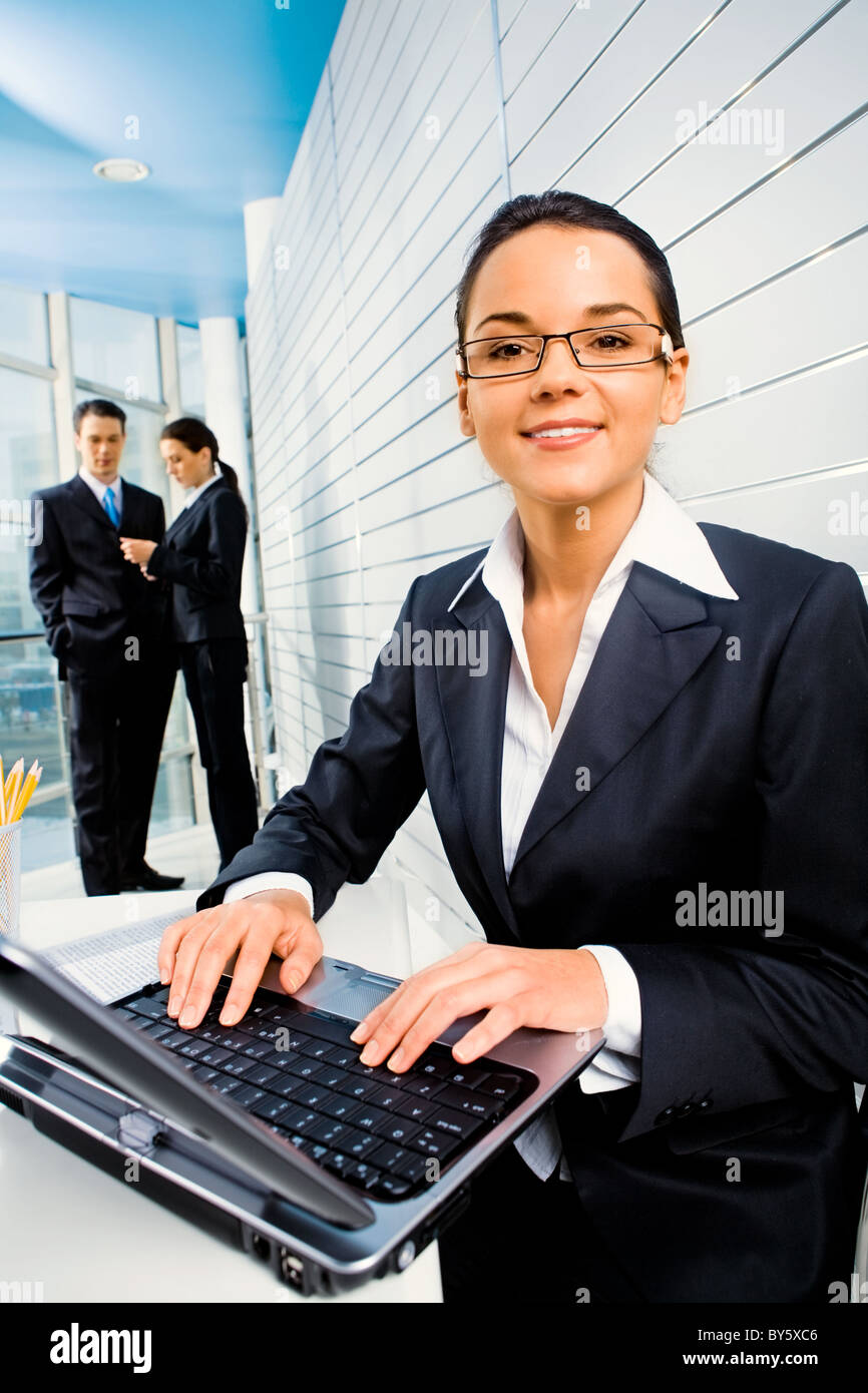 Successful woman doing some computer work on the background of business ...