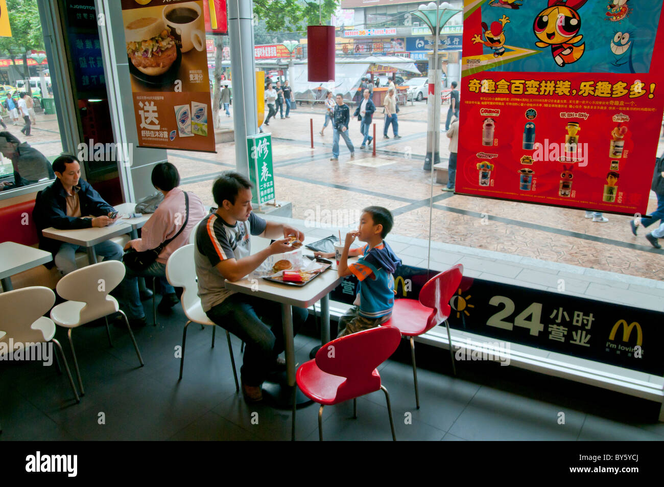 CHINA. FATHER AND SON EATING AT A MAC DONALDS RESTAURANT IN GUANGDONG ...