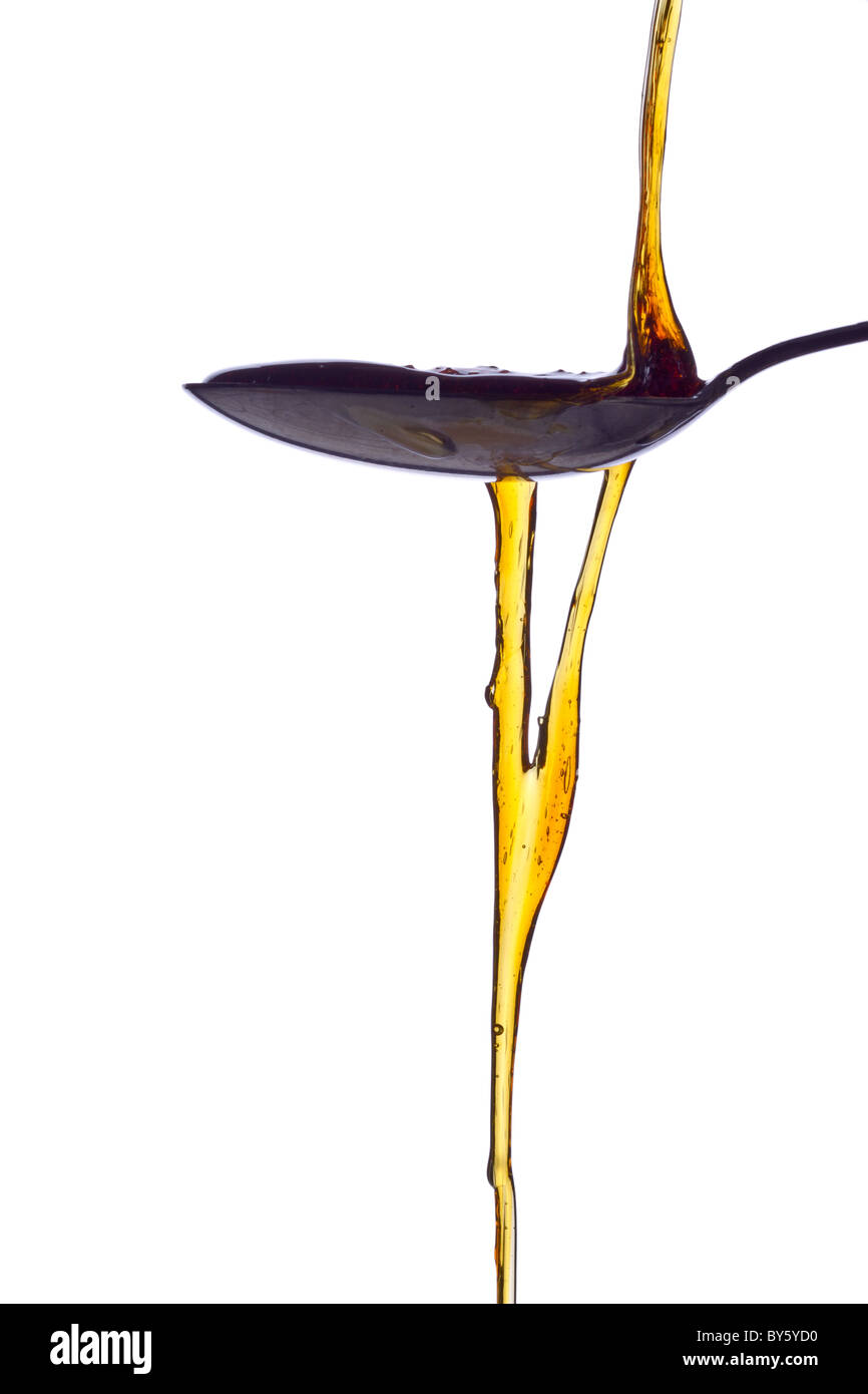 An inviting spoonful of syrup being poured out Stock Photo - Alamy